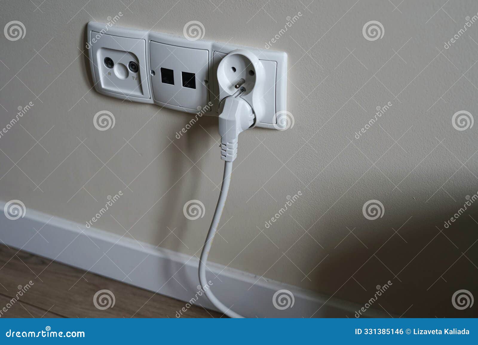A White Electrical Outlet on the Wall in the Room. an Electric Plug ...