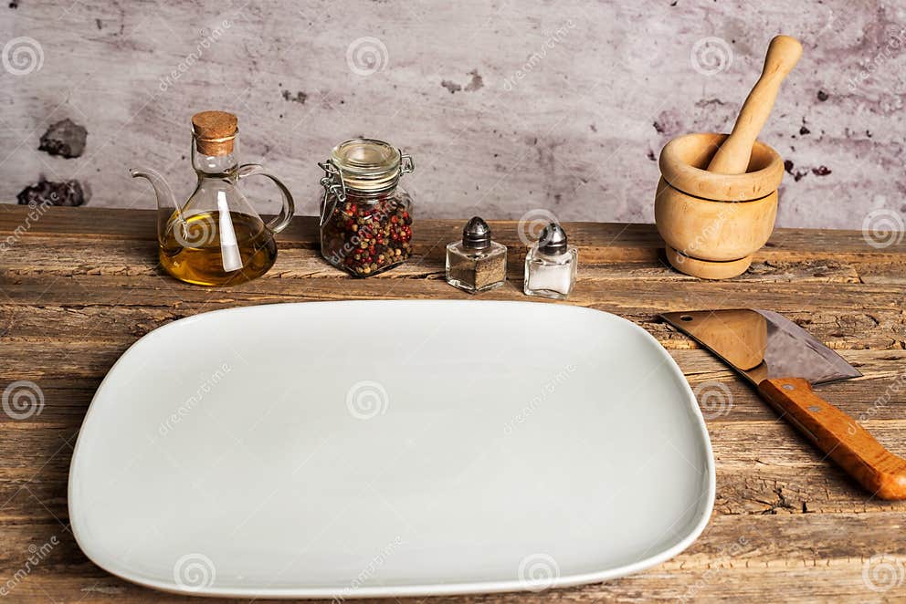 White Empty Rectangular Plate Next To Salt, Pepper, Oil and a Mortar on ...