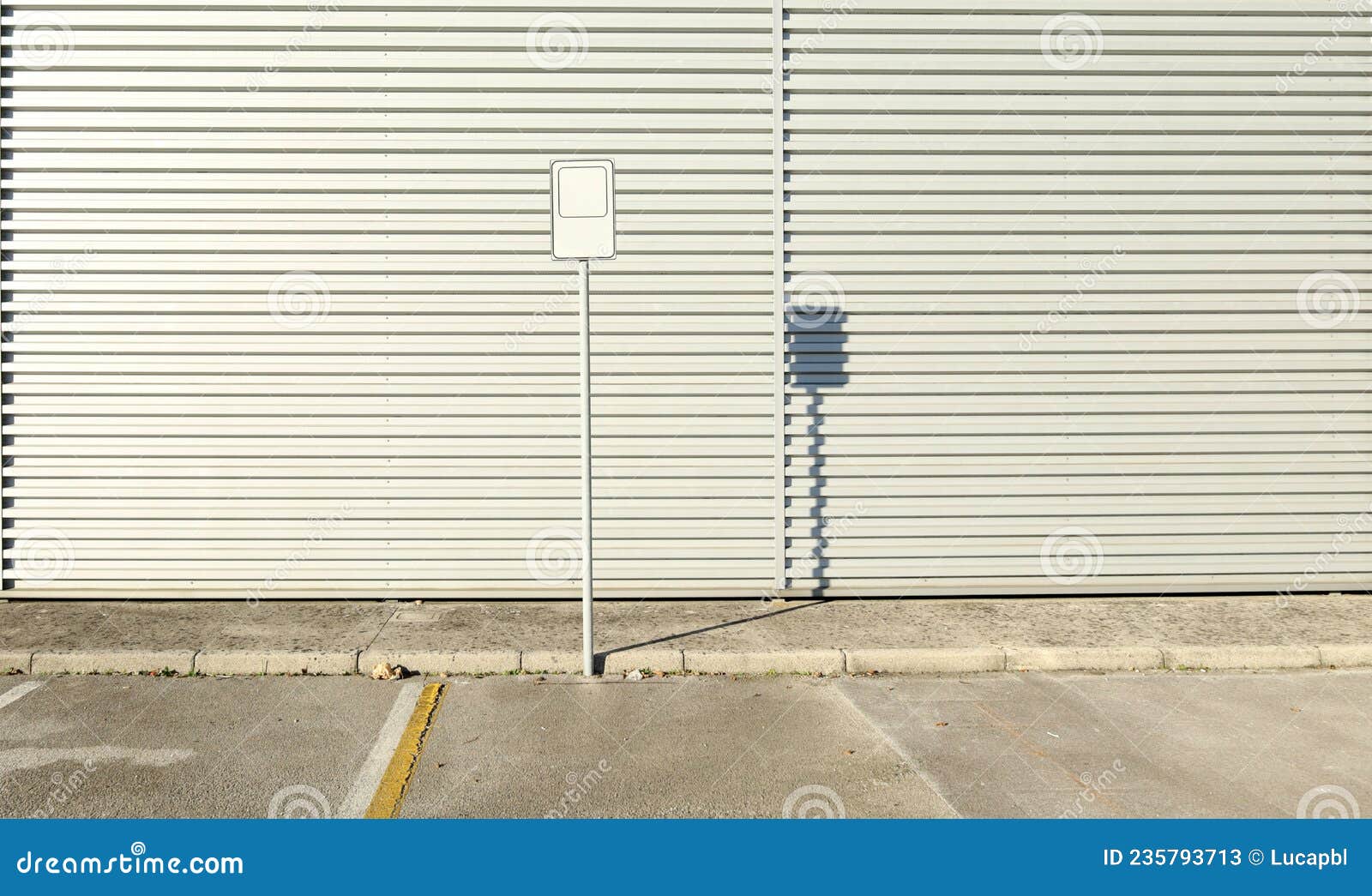 White Empty Sign on a Pole in Front of a White Aluminium Cladding Wall ...