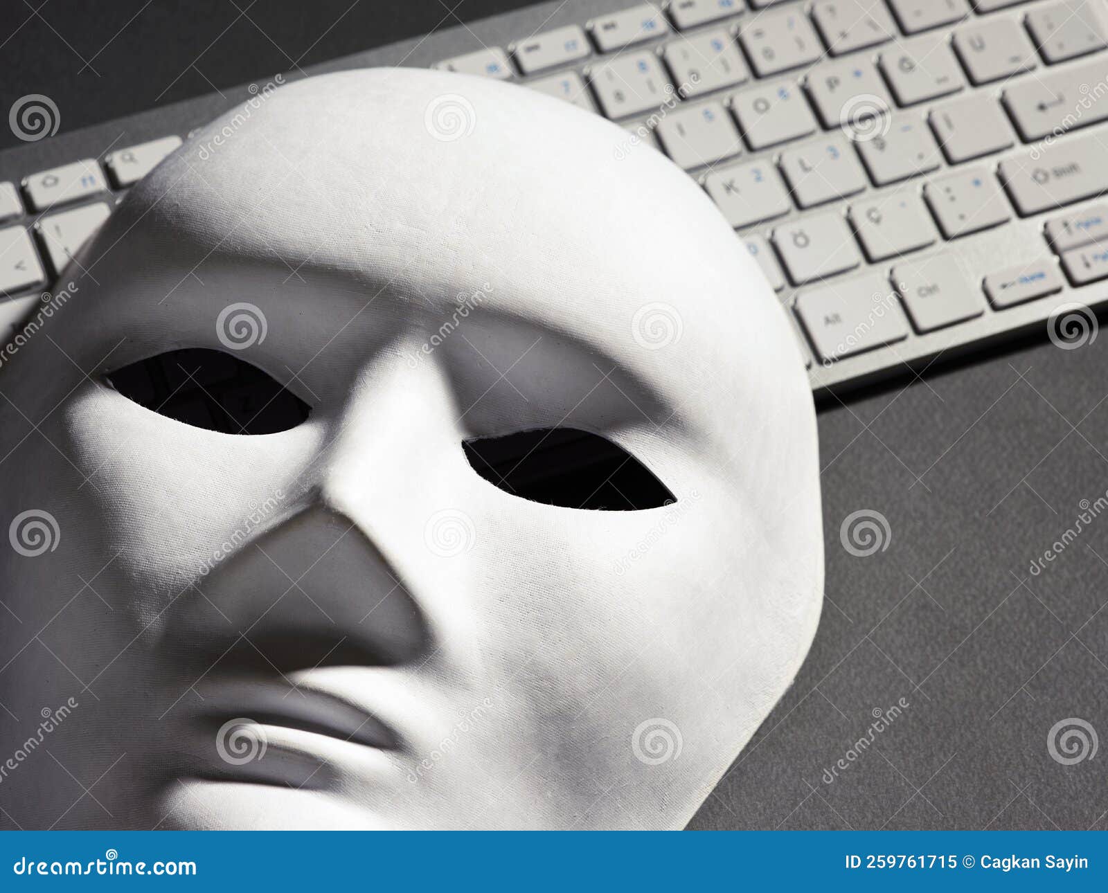 White Face Mask and Computer Keyboard on Black Background. Hacker ...