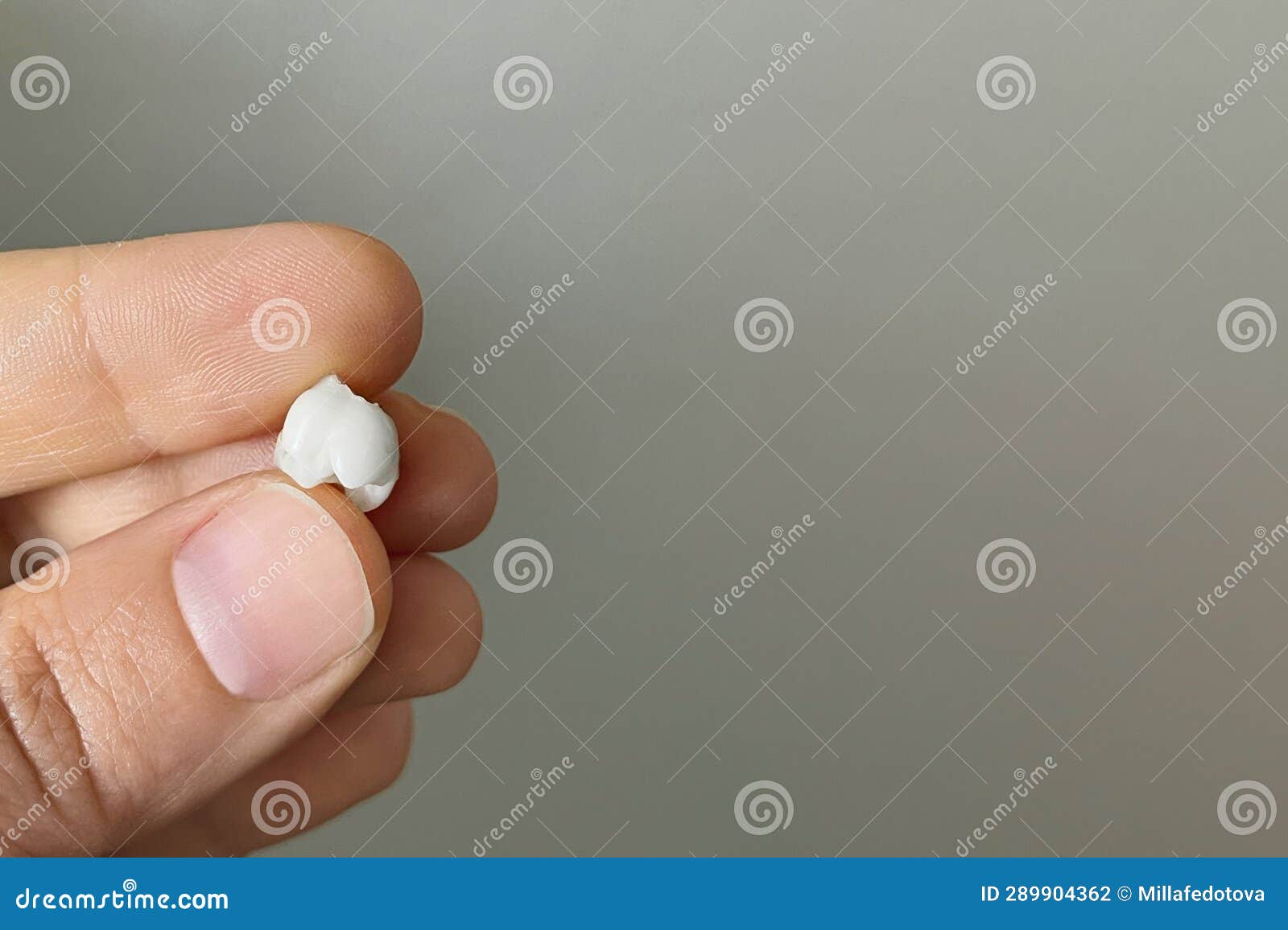 White Fallen Baby Tooth in Hand on Gray Background, Macro Stock Photo ...