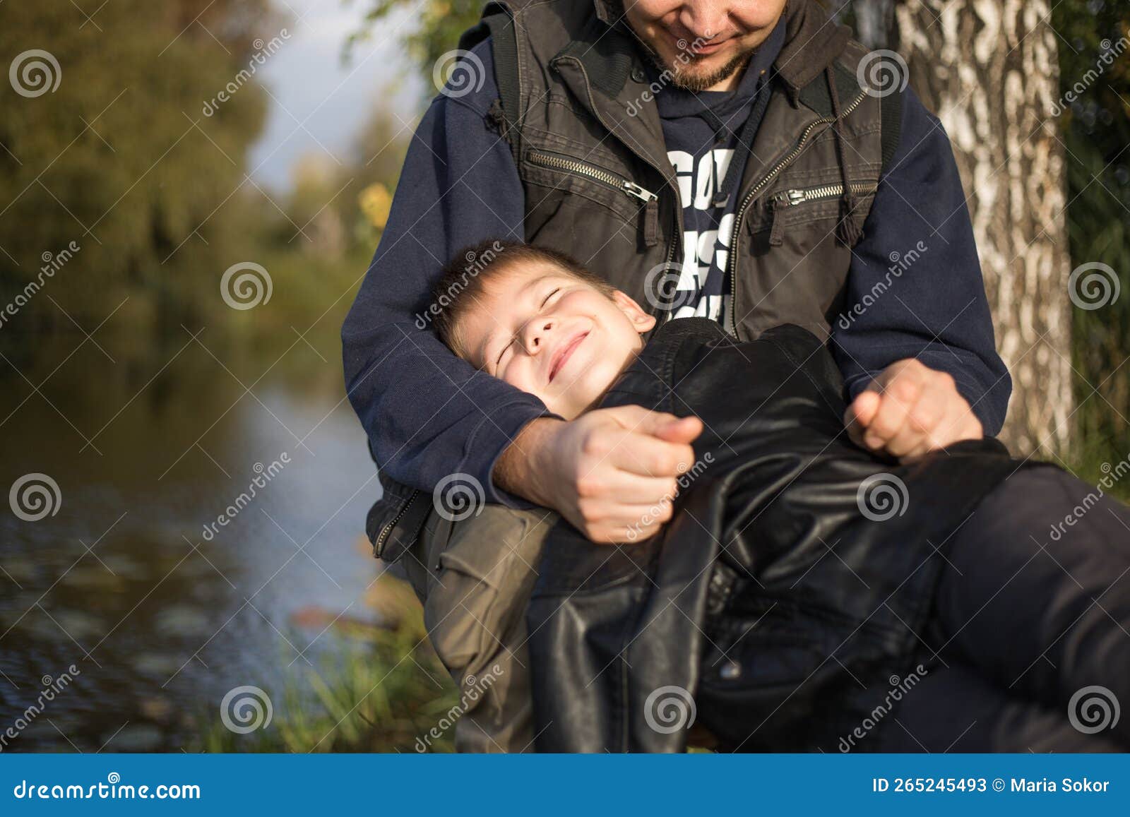 White Father Smiling while Walking with Her Sleeping Son Outdoor Stock ...