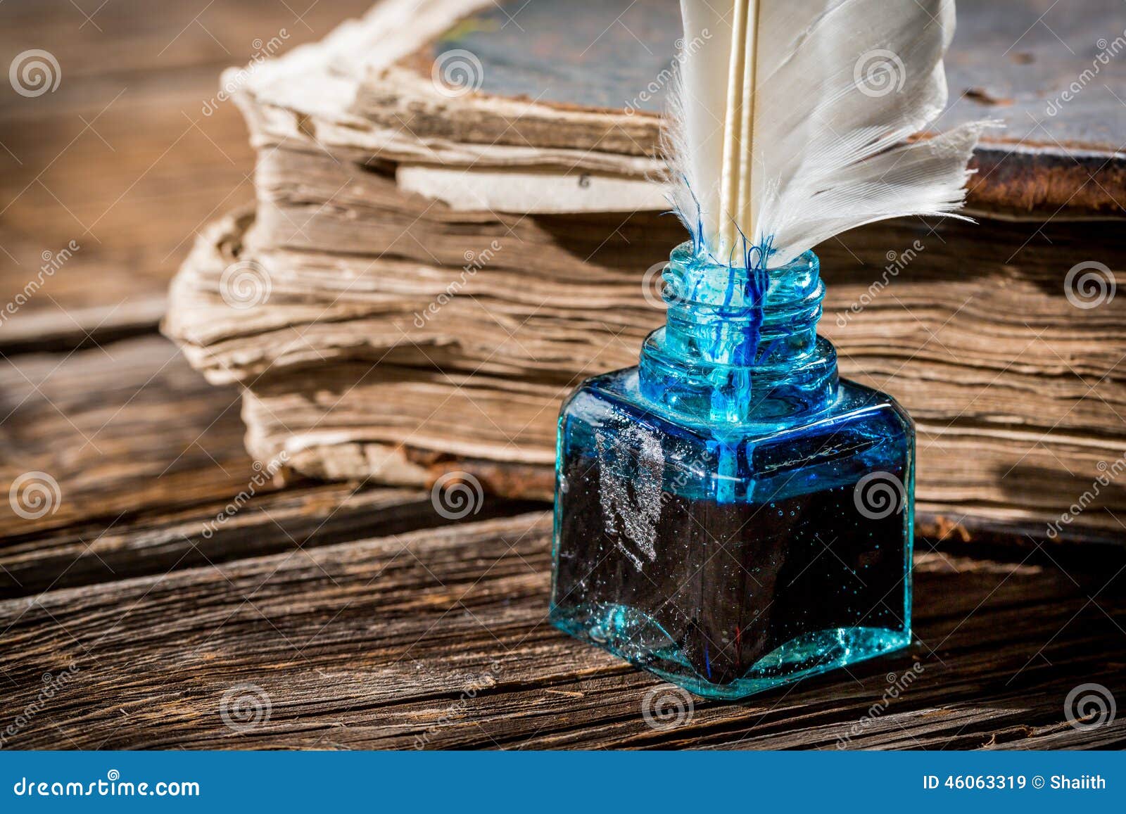 White Feather on Blue Inkwell and Old Book Stock Image - Image of ...