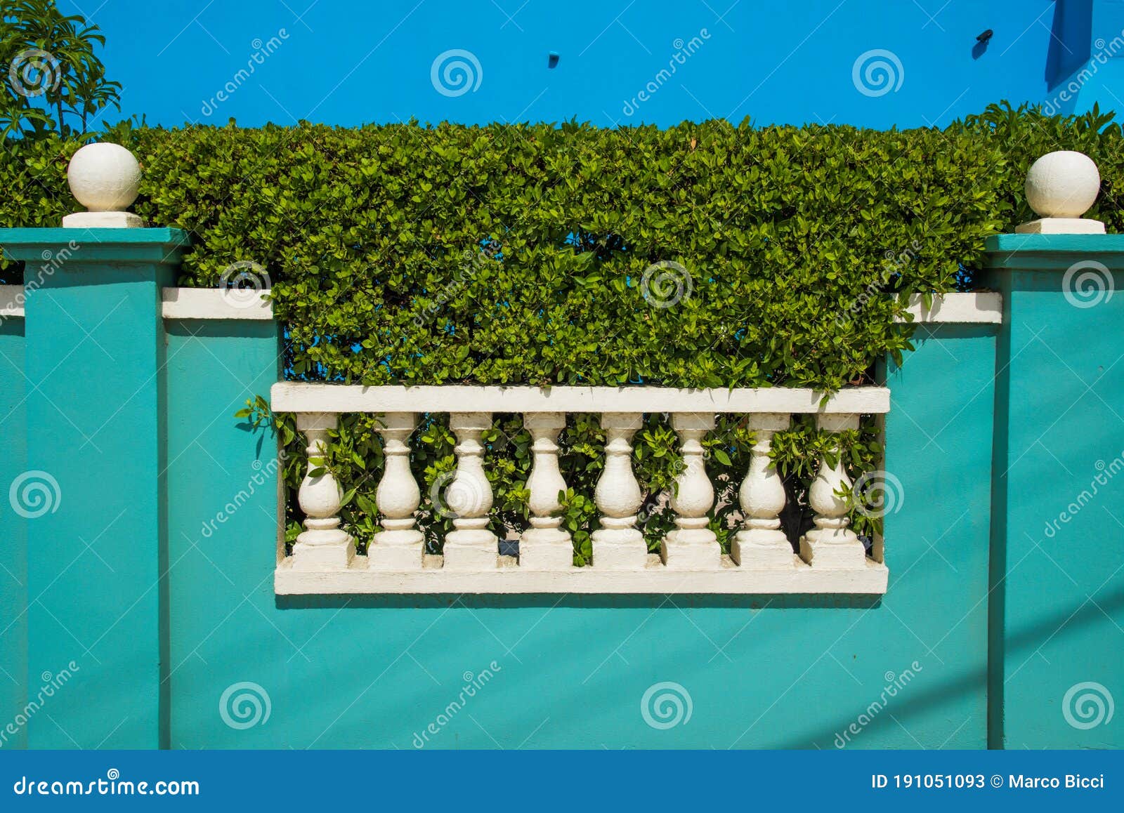 A White Fence with a Pastel-colored Wall Stock Image - Image of outdoor ...
