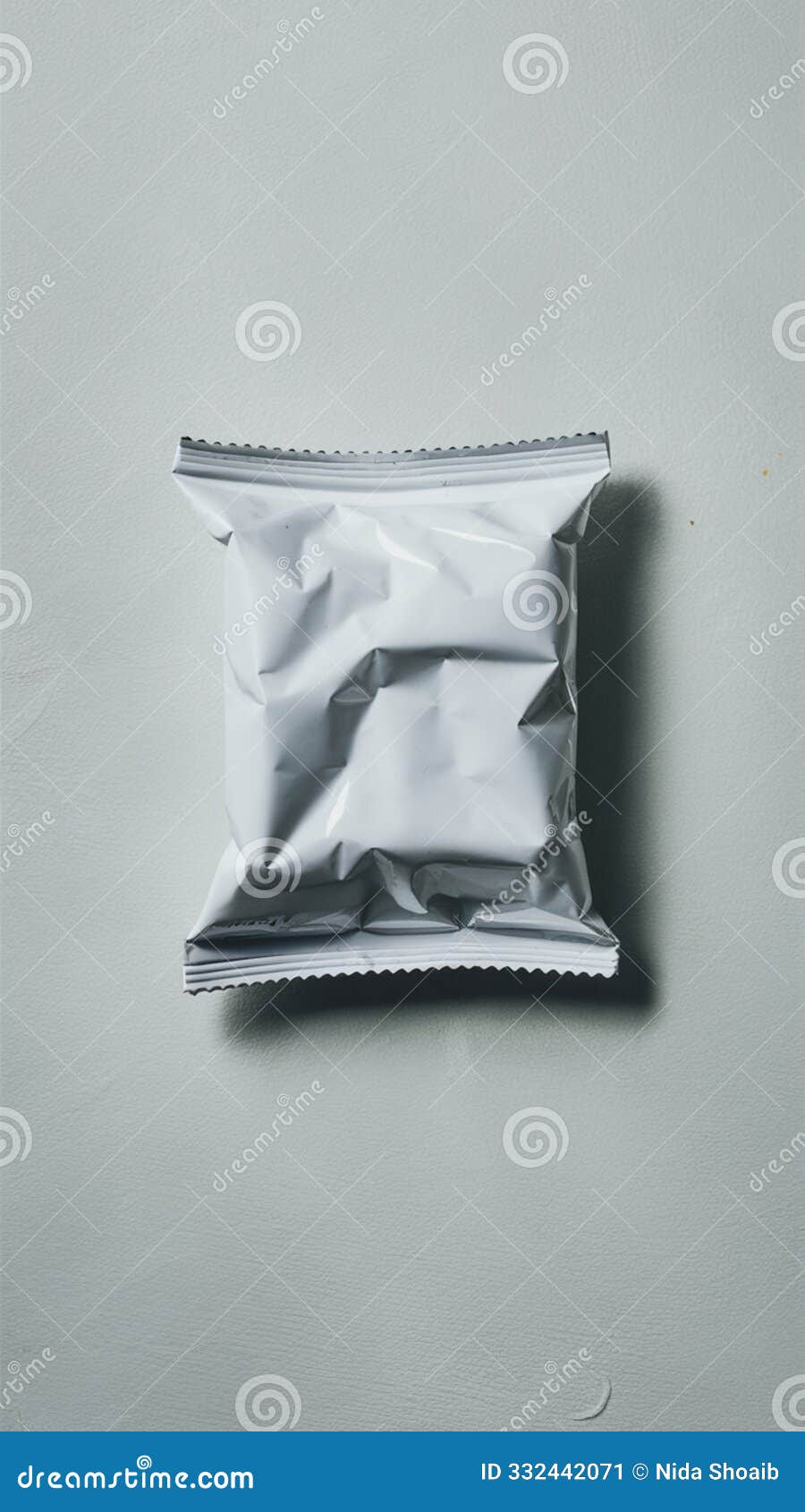 White, Flat Packed Object with Slight Wrinkles Rests on Light Gray ...