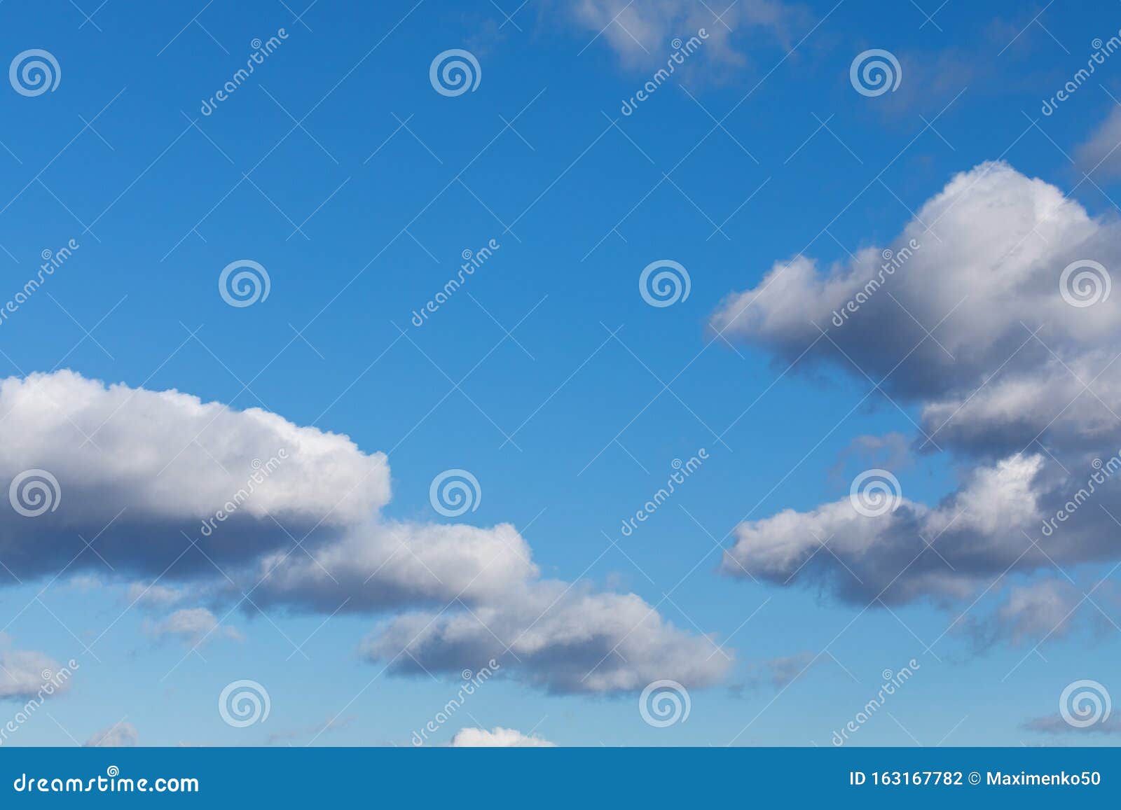 White, Fluffy Cloud Float Along the Skyline Over Blue Sky on a Clear ...