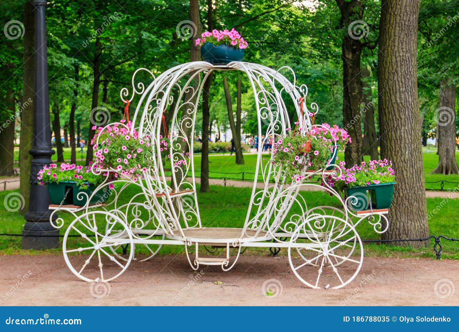 White Forged Decorative Coach with Flowers in Park Stock Image - Image ...