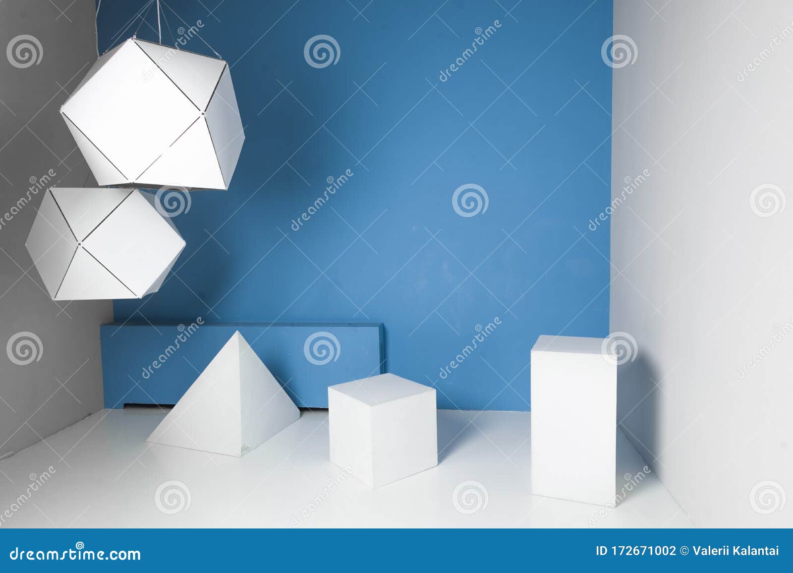 White Geometric Shapes in Room with Blue Wall Stock Photo - Image of ...