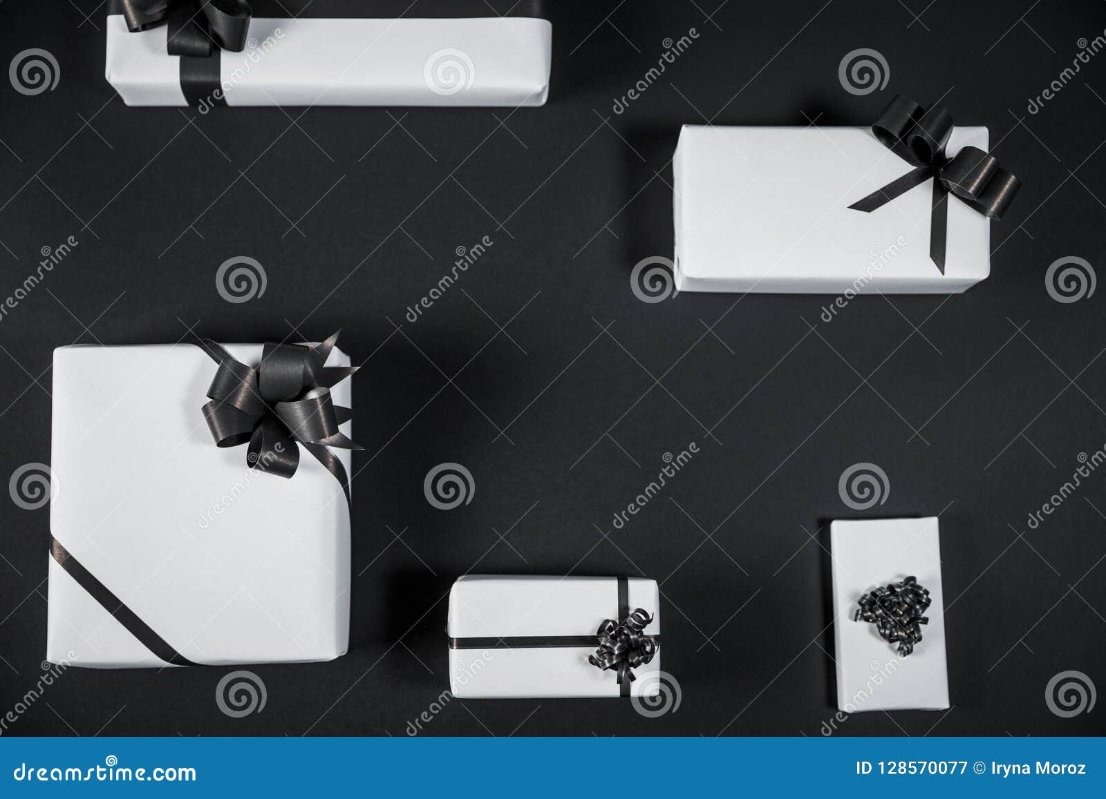 White Gift Box on a Dark Contrasted Background, Decorated with a Stock ...