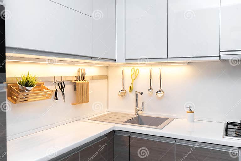 White Gloss Kitchen Interior with Worktop Lighting Stock Photo - Image ...