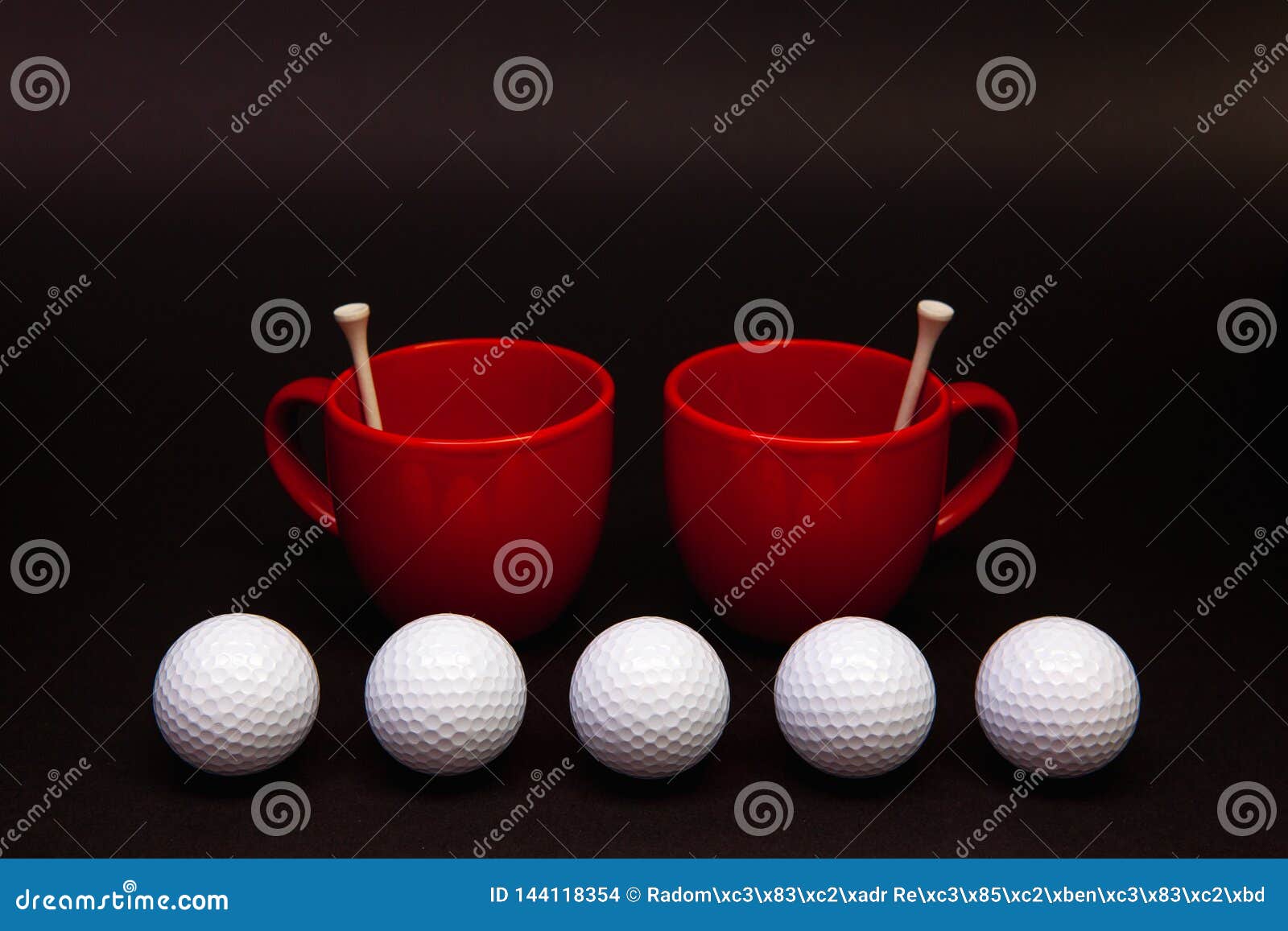 White Golf Balls And Red Cups Of Tea On The Black Table Stock Photo ...