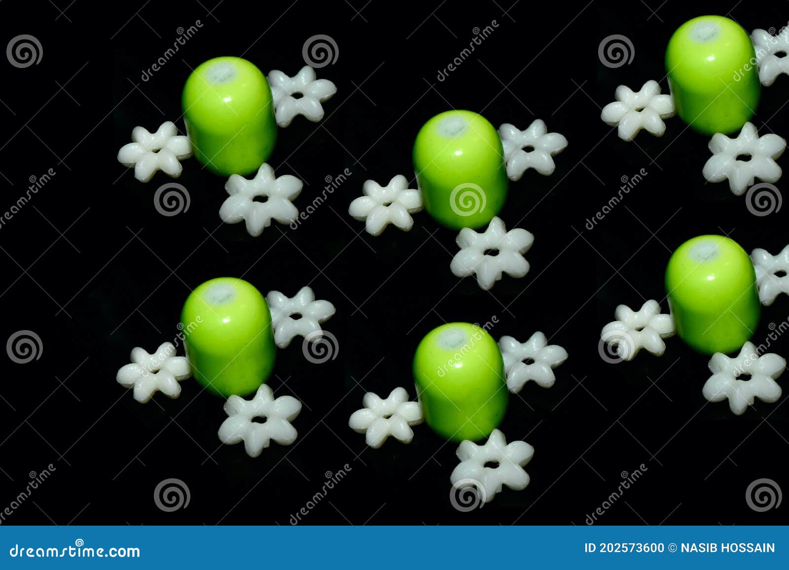 White and Green Small Plastic Objects on a Black Surface Stock Photo ...