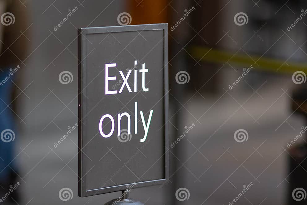 White on Grey Exit only Sign Shallow Depth of Field Stock Image - Image ...