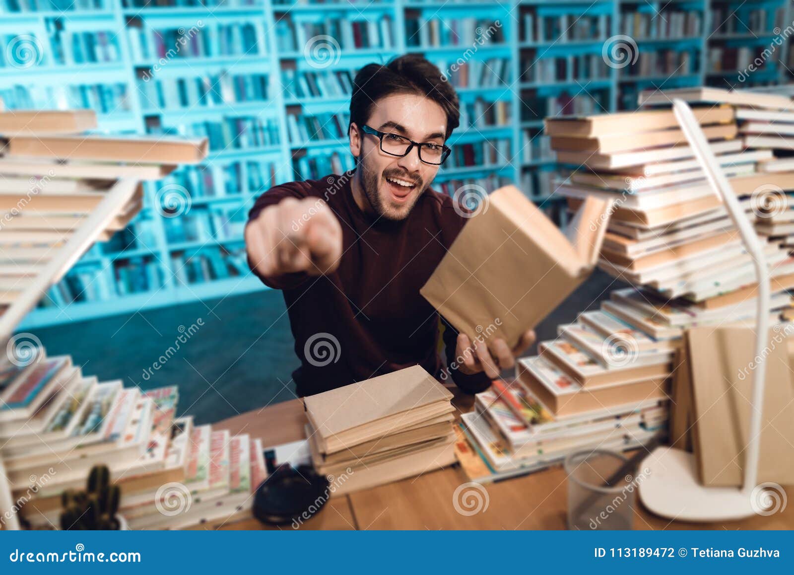 White Guy Surrounded by Books in Library. Student is Emotionally ...
