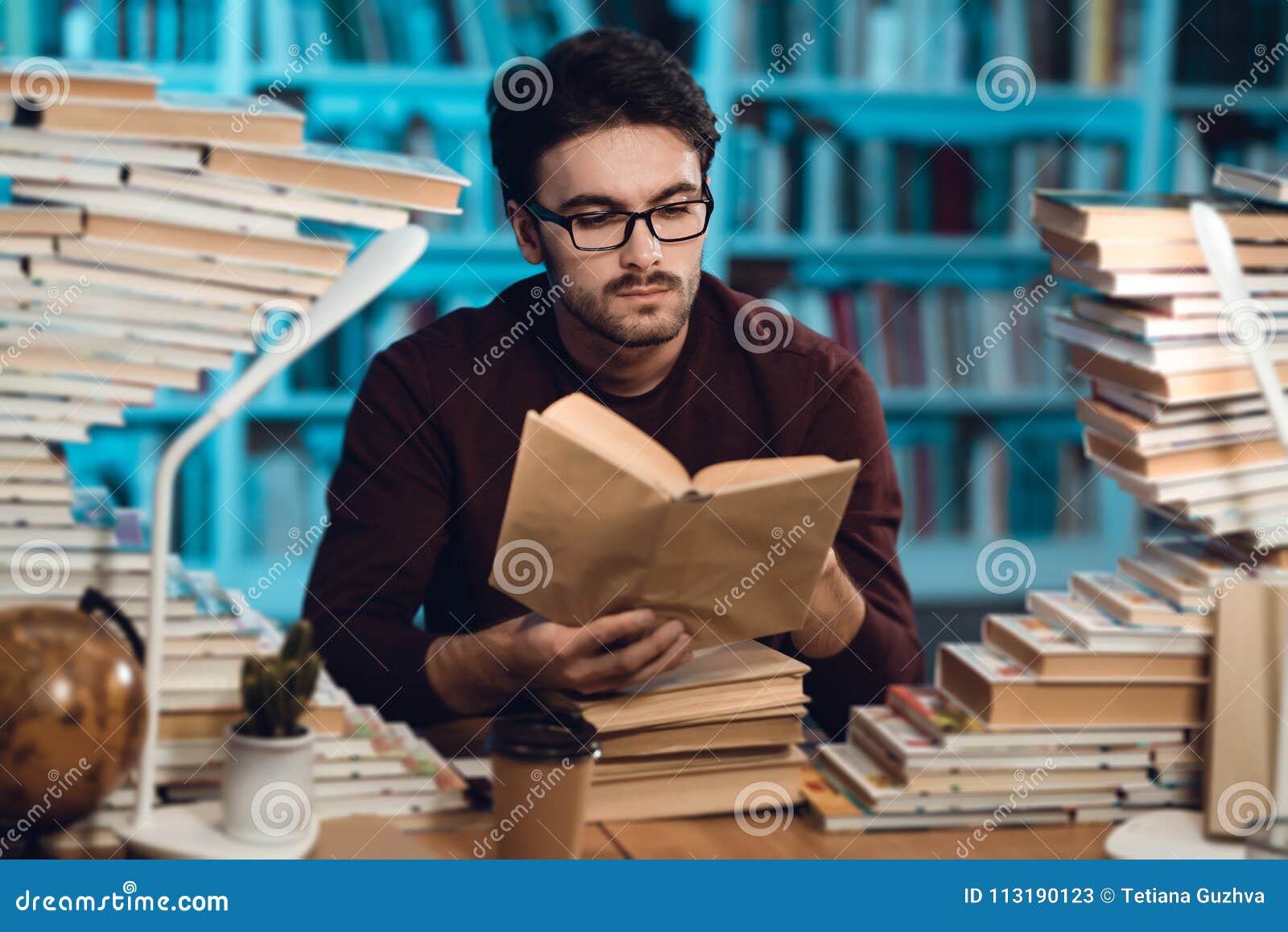 White Guy Surrounded by Books in Library. Student is Reading Book ...