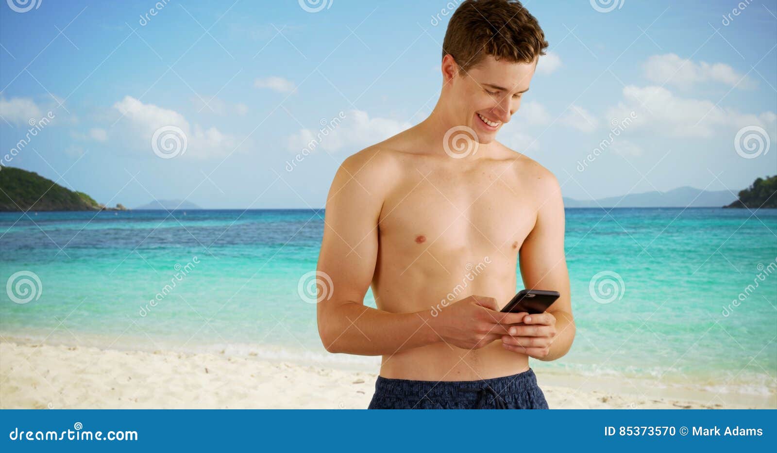 White Guy Wearing Swim Shorts Using Smart Phone To Read Text Messages ...