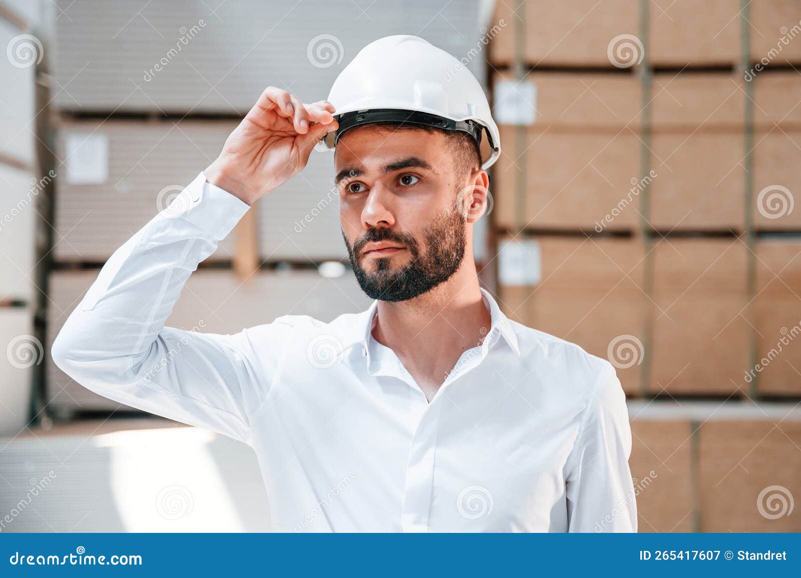 In White Hard Hat. Storage Worker is in the Warehouse with Bunch of ...