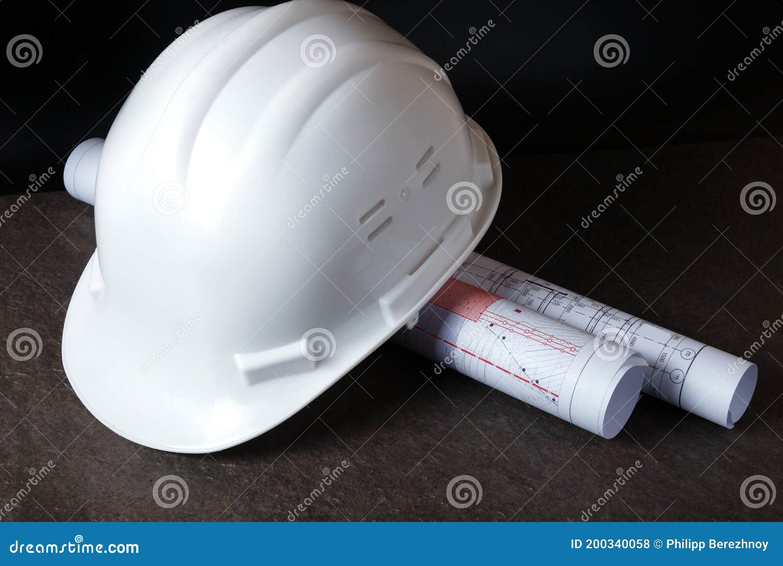 White Hardhat and Rolled Engineering Drawings at Engineer Workplace ...