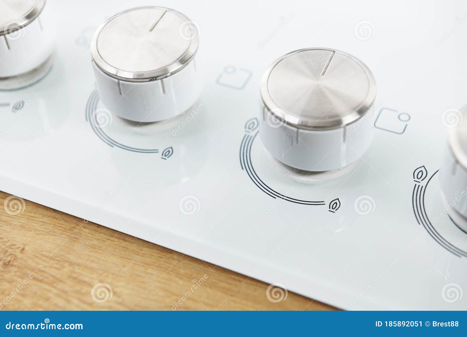 White Hob Glass Gas Panel with Integrated Controls. Close-up Adjustment ...