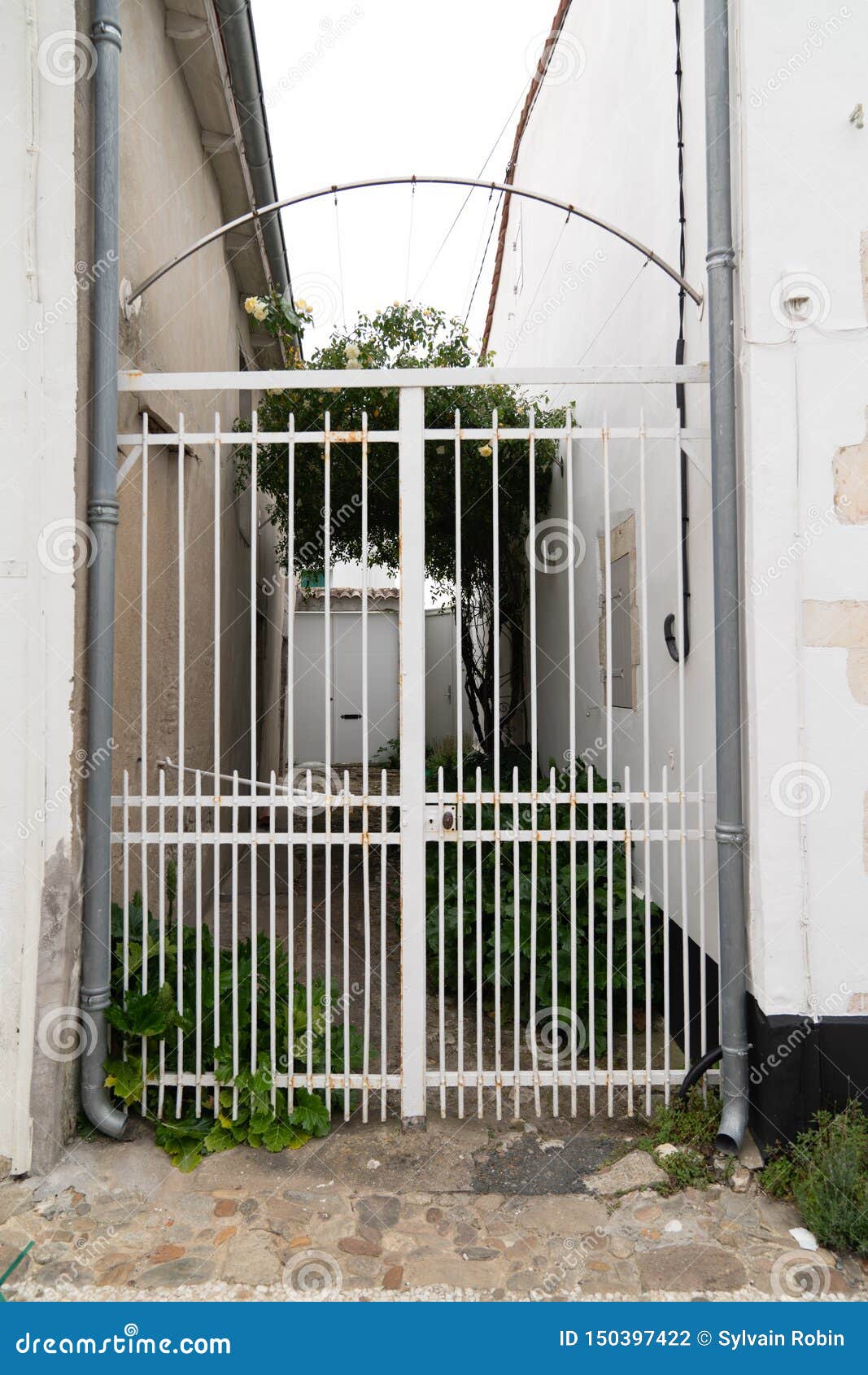White Home Gate in the Alley between Two Houses Stock Photo - Image of ...