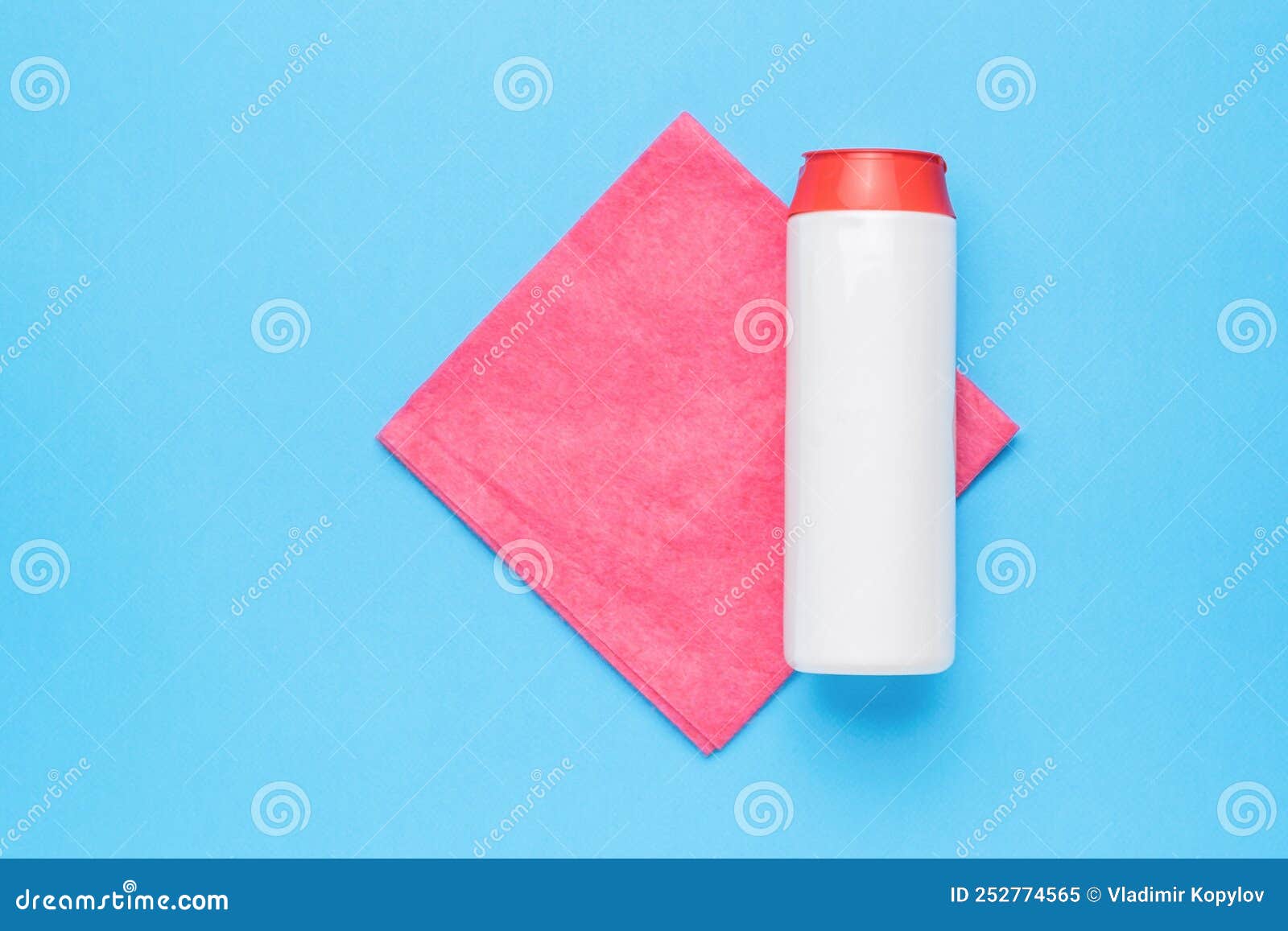 A White Jar with Cleaning Agent and a Red Cleaning Cloth on a Blue ...
