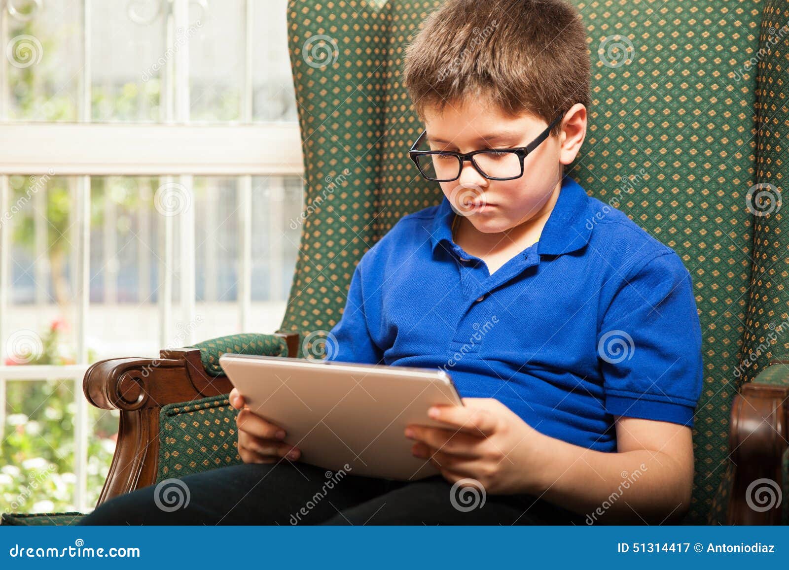 White kid using a tablet stock image. Image of room, interesting - 51314417