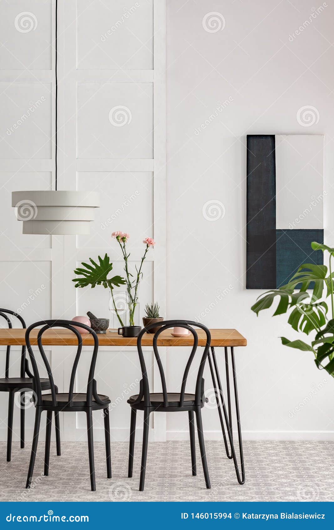 Lamp Above Wooden Table with Black Chairs Stock Photo - Image of design ...