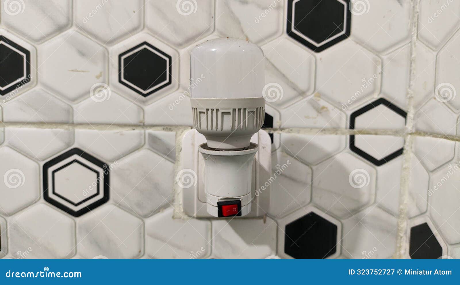 White LED Light Bulb Installed in a Hexagon Tile Wall Stock Image ...