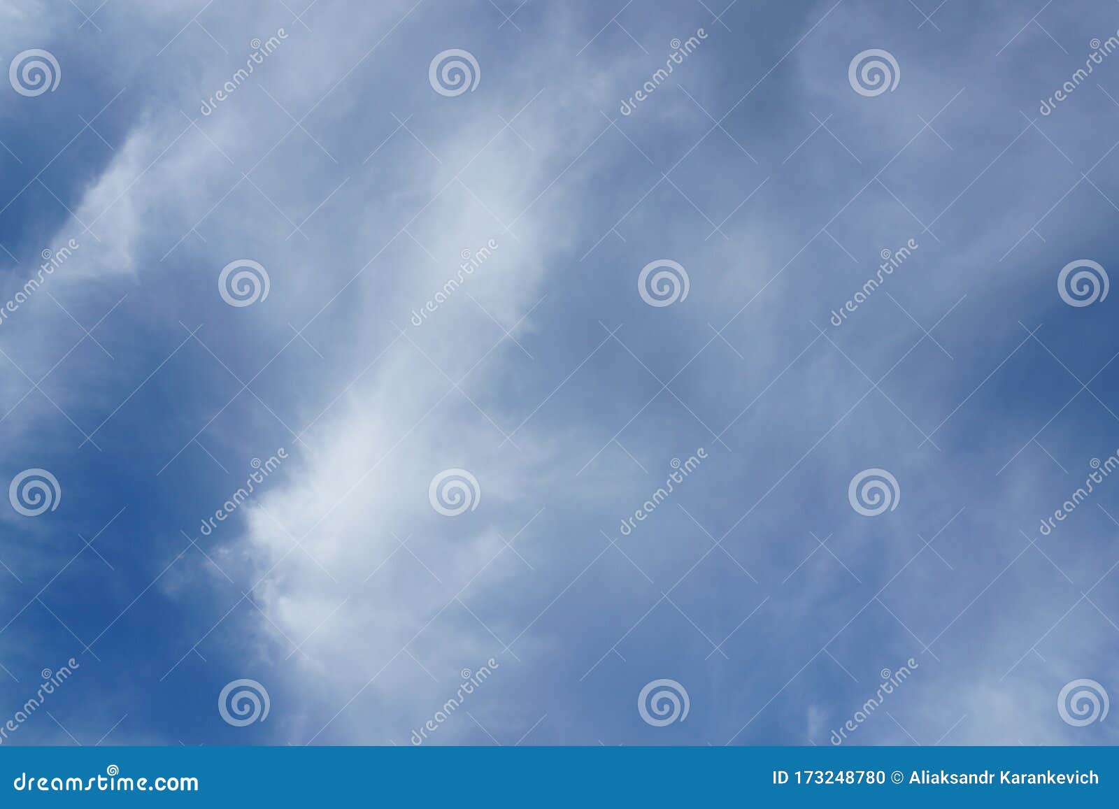 White Light Fluffy Clouds in a Blue Sky with a Solar Flare Stock Photo ...