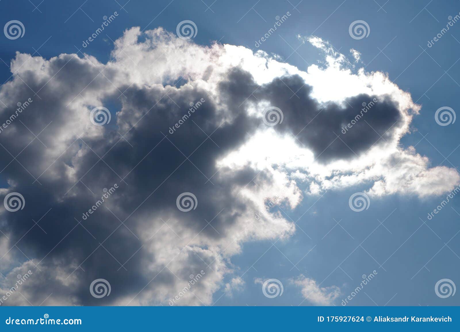 White Light Fluffy Clouds in a Blue Sky with a Solar Flare Stock Photo ...
