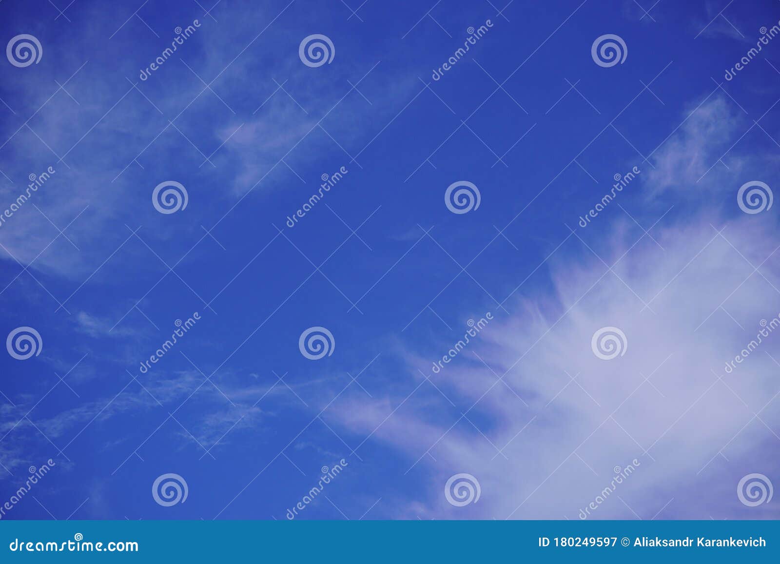 White Light Fluffy Clouds in a Blue Sky with a Solar Flare Stock Image ...