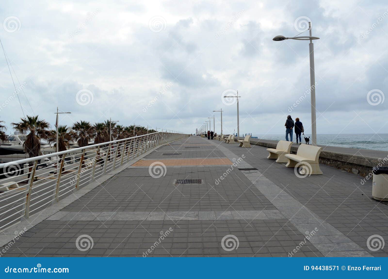 White Lighthouse at the Bottom of the Road Stock Image - Image of ...