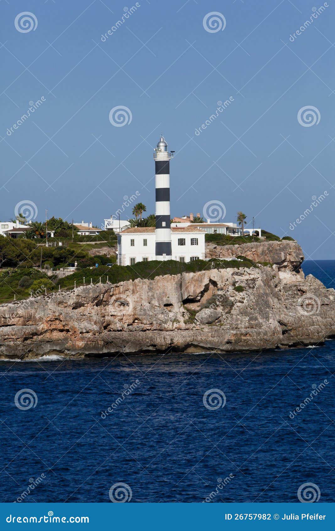 White Lighthouse on Rocks in the Sea Ocean Water Sky Blue Stock Photo ...