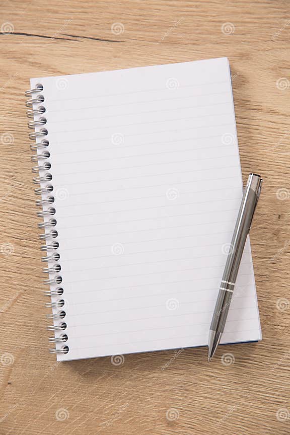 White Lined Notepad with a Metal Ring Wire Binding and a Silver Pen ...