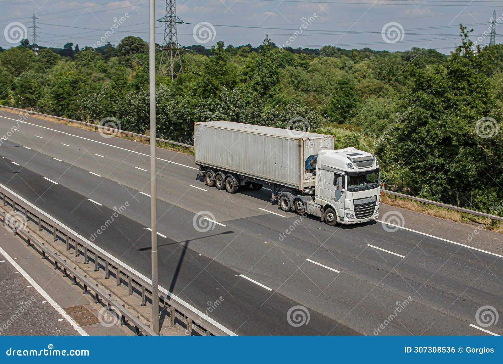 White Lorry with Shipping Container in Motion on the Motorway Stock ...