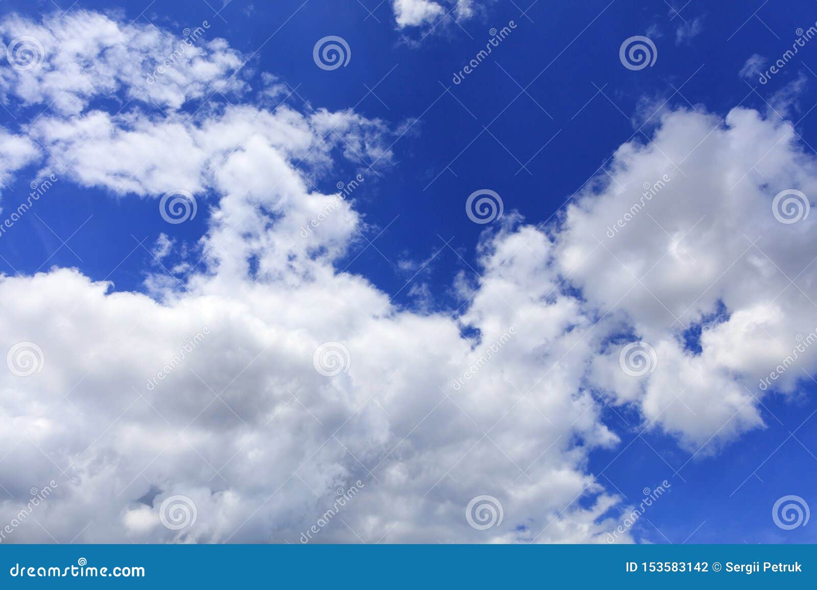 White Lush Clouds Float in the Bright Saturated Blue Sky Stock Photo ...