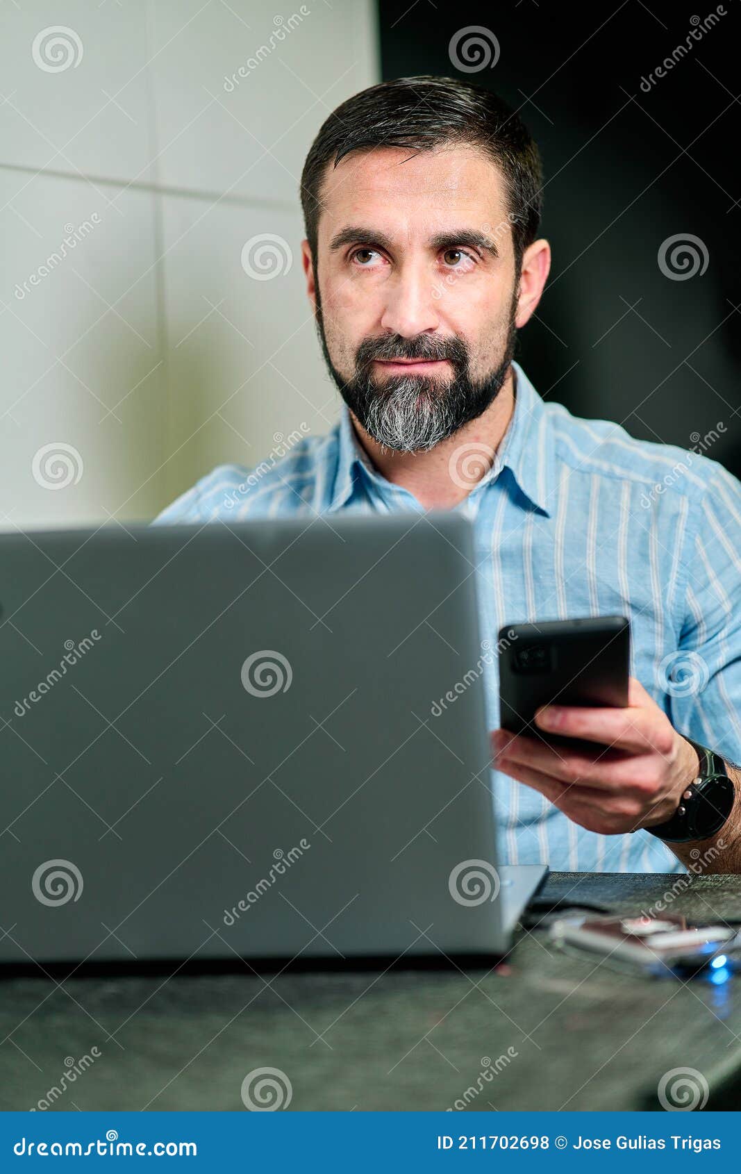 White Man with Beard Working on Laptop and Looking Up Stock Photo ...