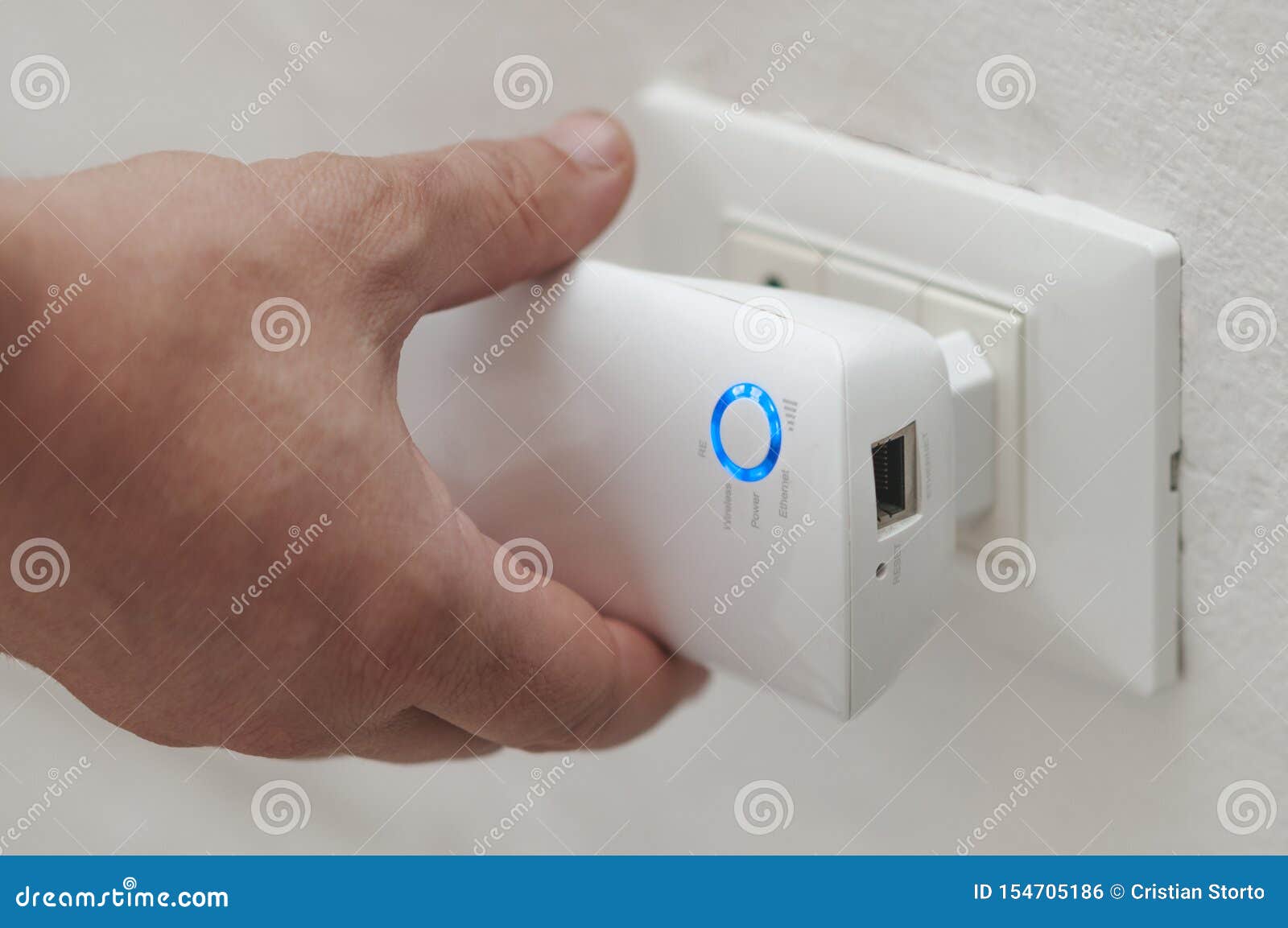 Insert Ethernet Cable Into WiFi Extender Device Which Is In Electrical ...