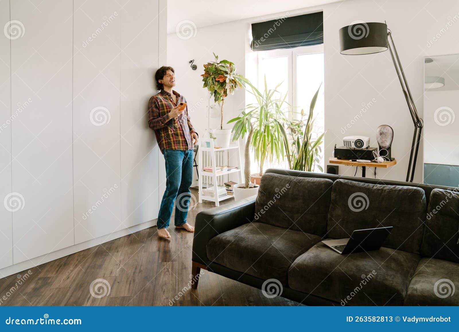 White Man Laughing and Using Mobile Phone at Home Stock Image - Image ...
