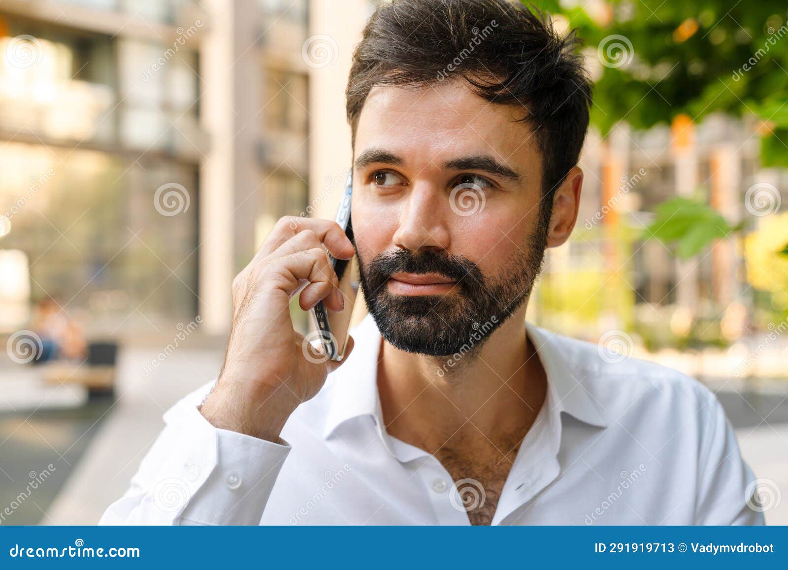 White Man Talking On Mobile Phone While Standing At City Street Stock