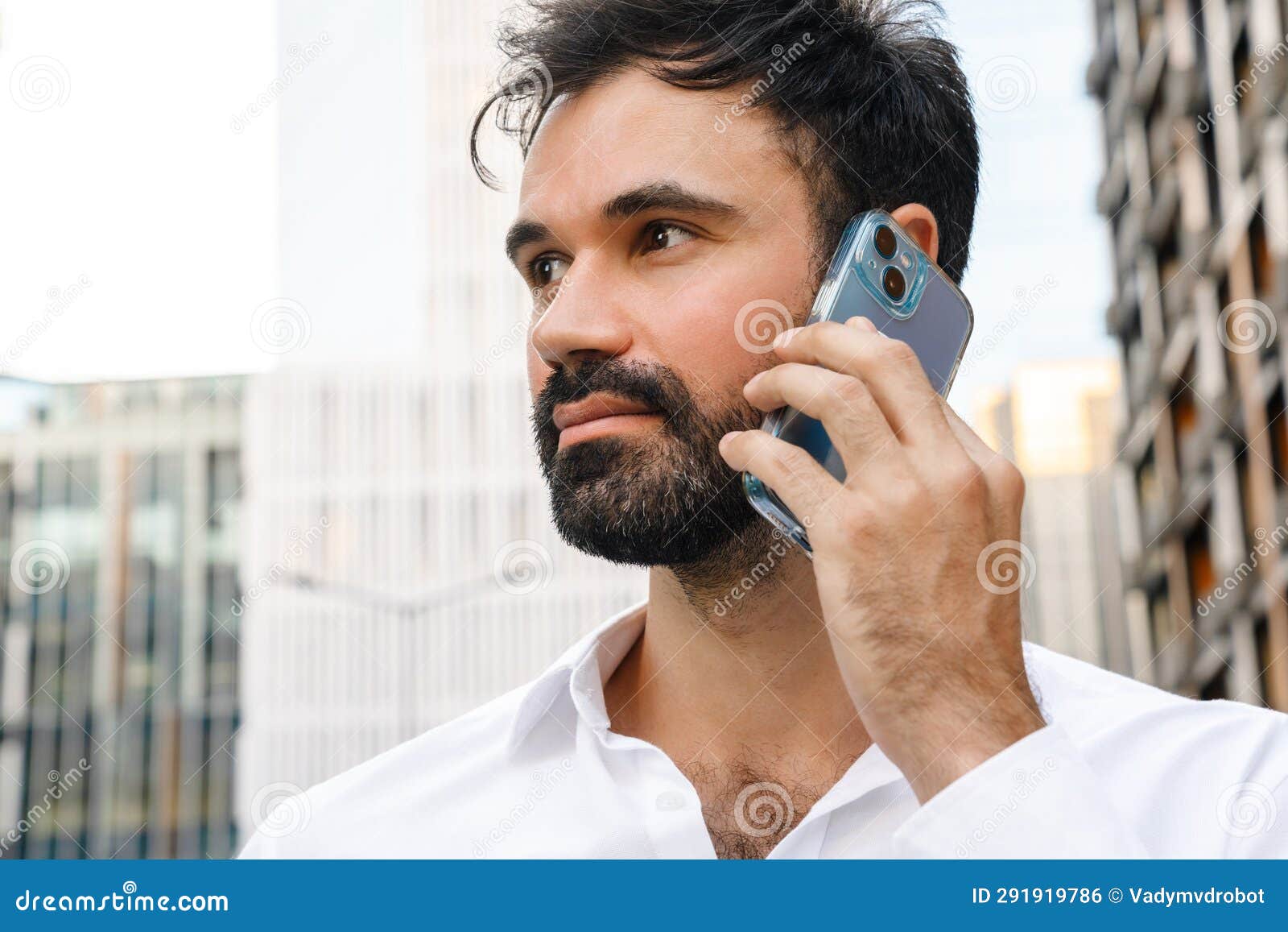 White Man Talking On Mobile Phone While Standing At City Street Stock