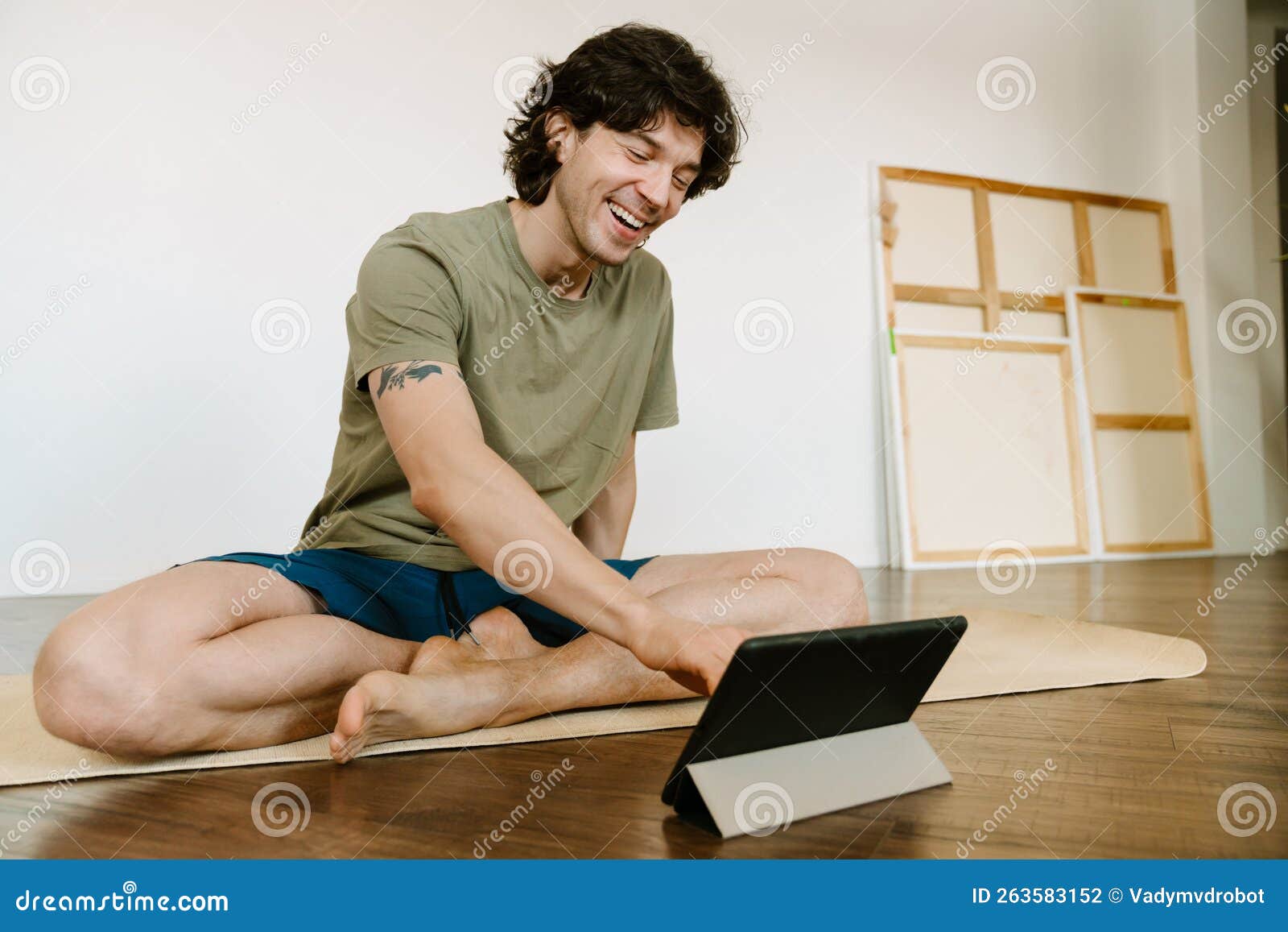 White Man Using Tablet Computer during Yoga Practice Stock Photo ...