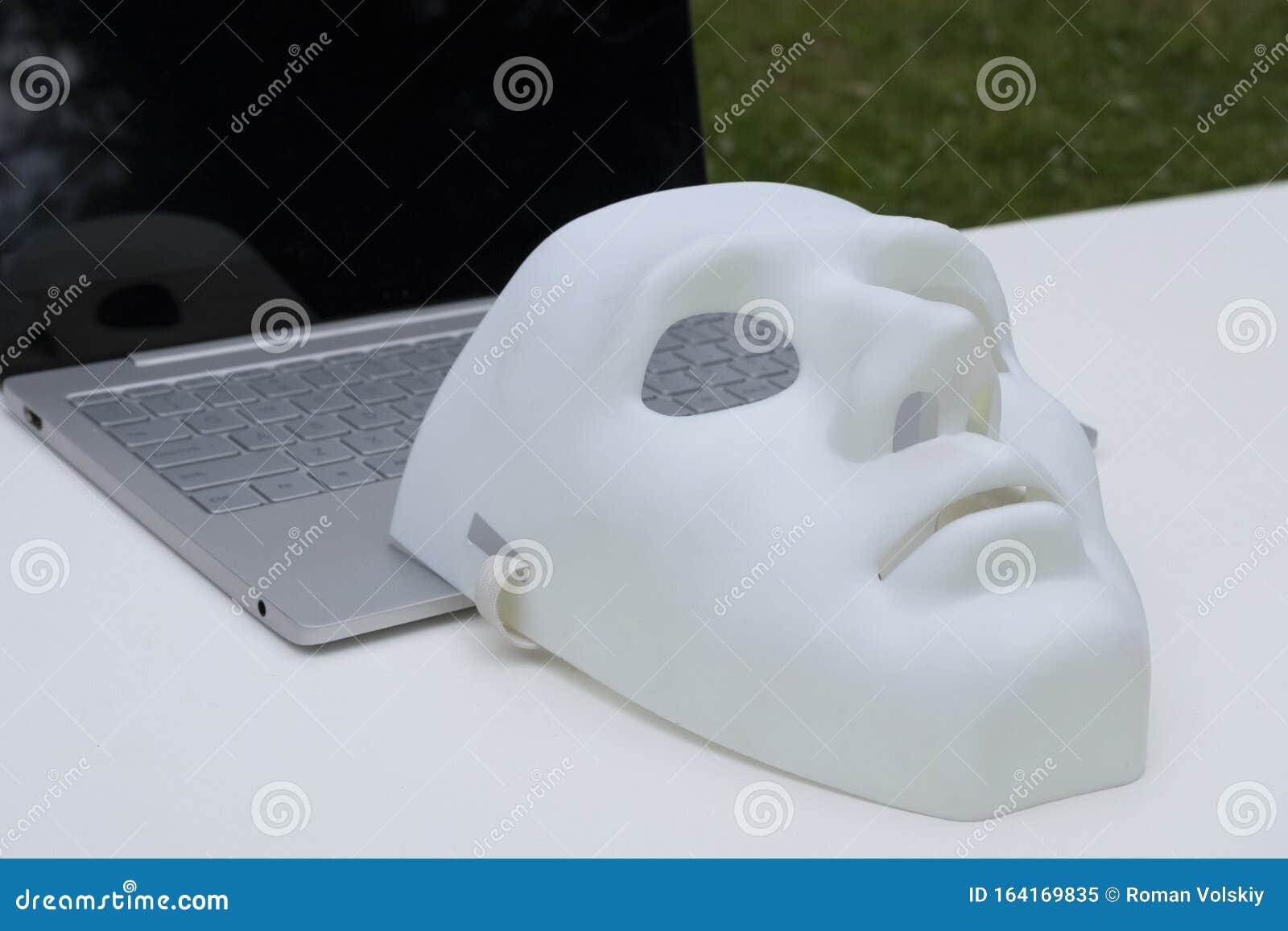 White Mask and Laptop Closeup. the Concept of Hackers in Nature. Remote ...