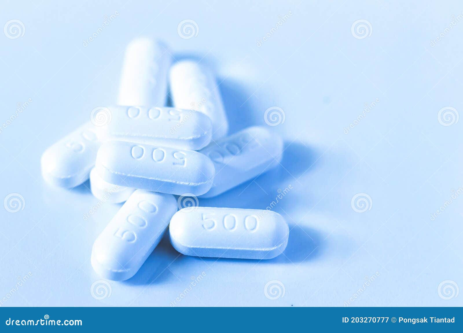 White Medical Pill On Blue Background With Copy Space For Your Text Or