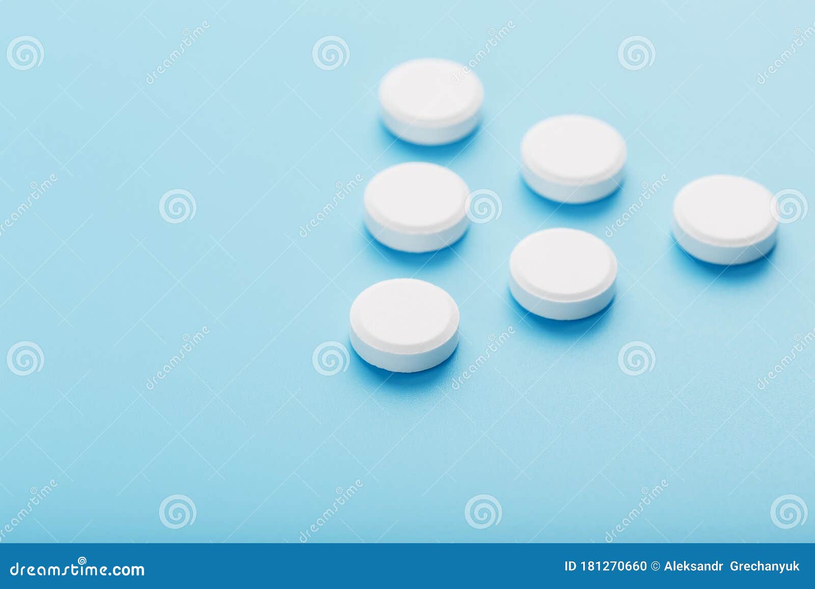 White Medicinal Tablets in the Shape of a Pyramid on a Blue Background ...