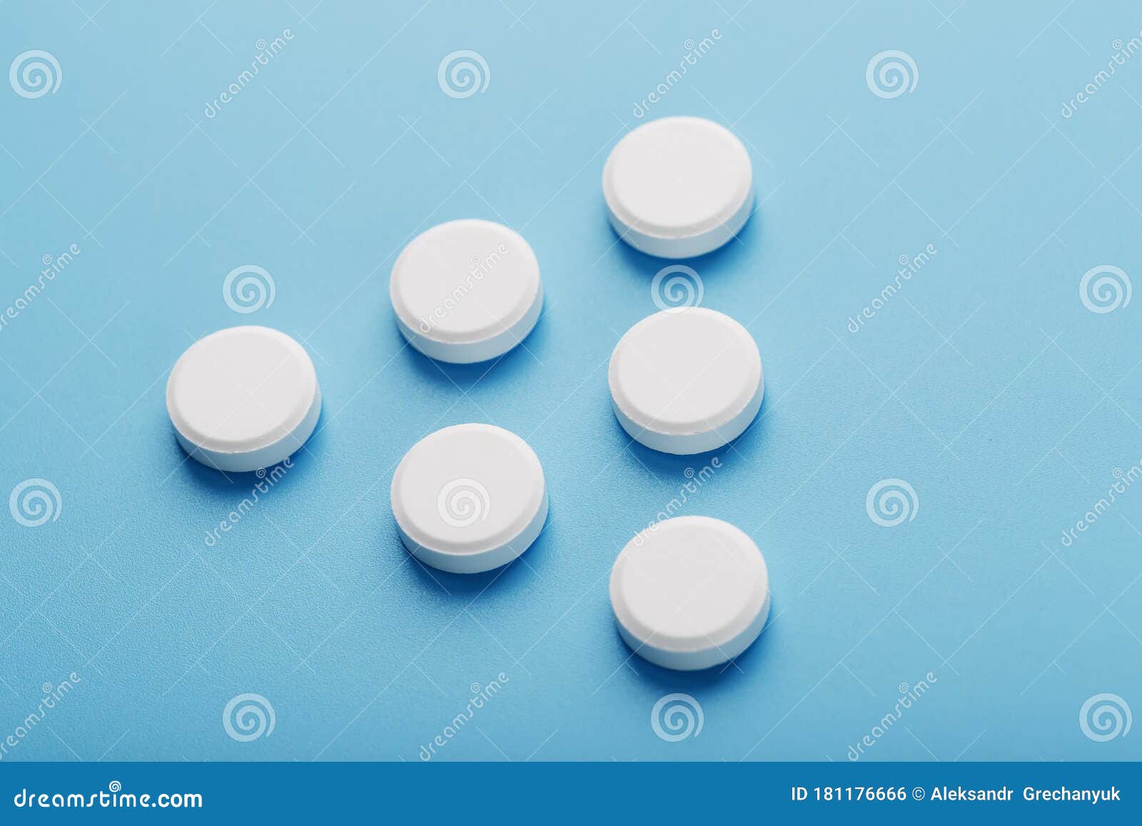 White Medicinal Tablets in the Shape of a Pyramid on a Blue Background ...