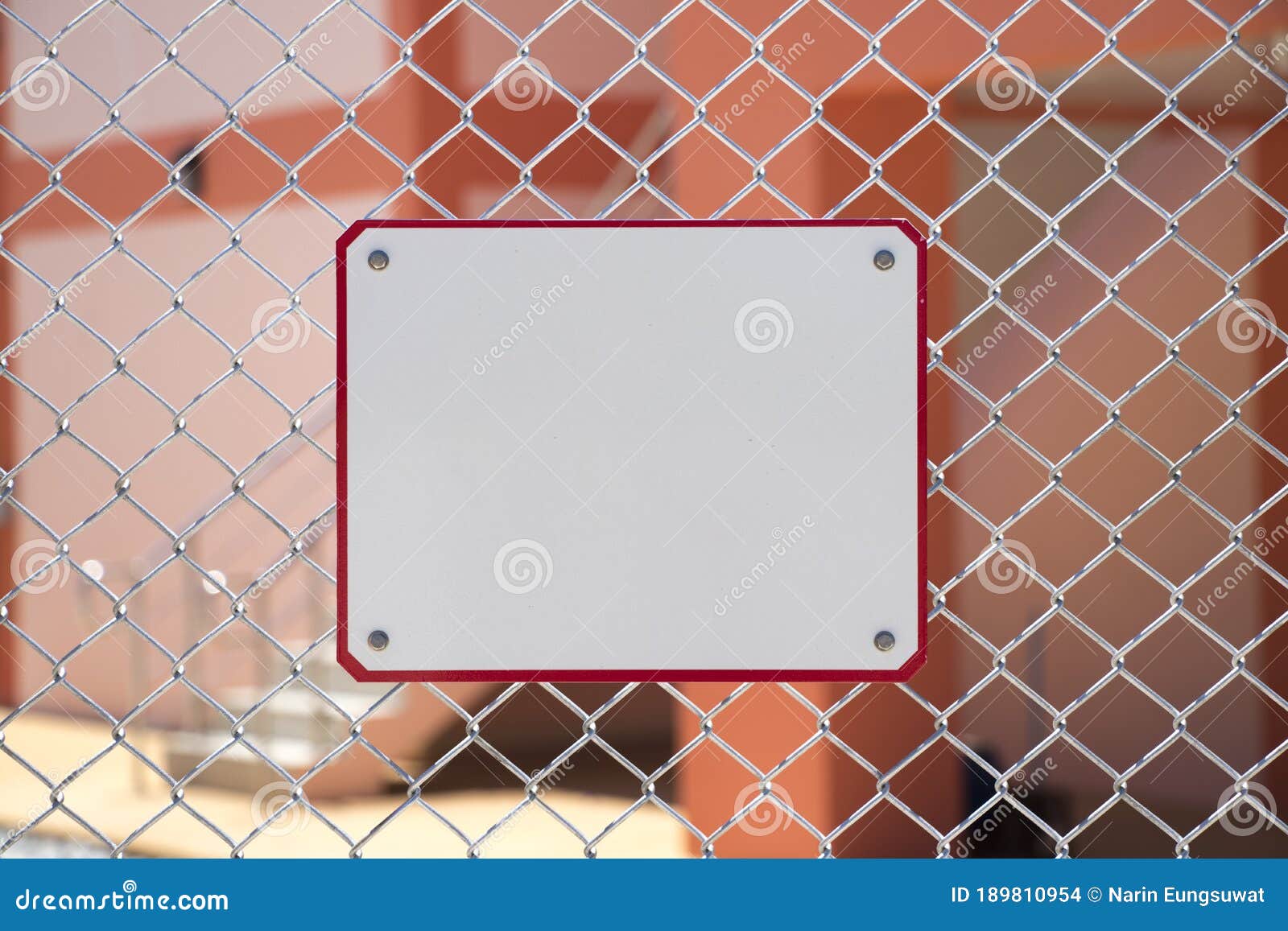 The White Metal Sign is Installed on the Metal Mesh Fence. Stock Photo ...