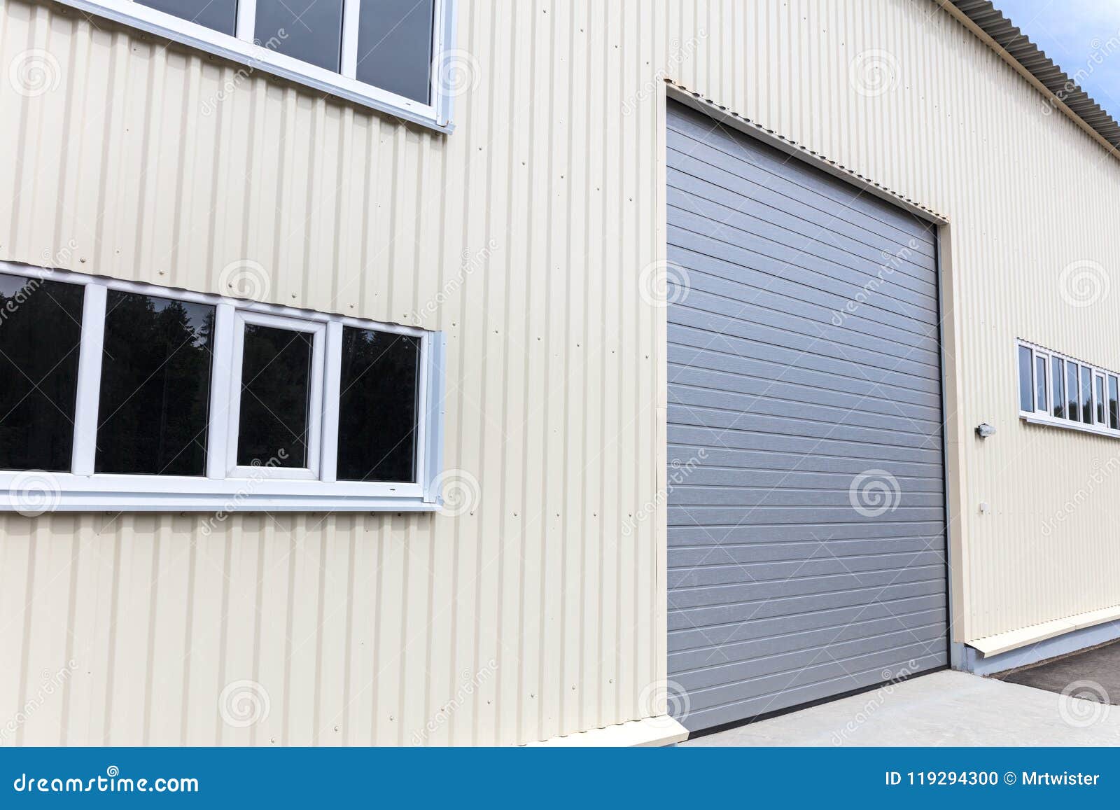Metal Warehouse Wall with Windows and Closed Gate Stock Photo - Image ...