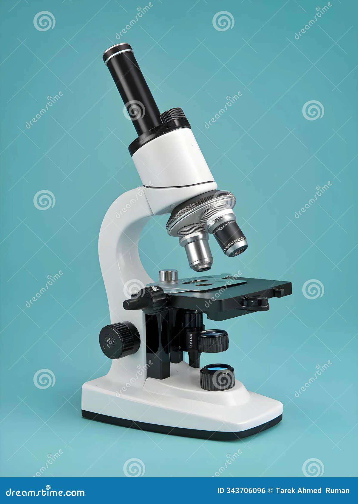 A White Microscope with Black Accents is Positioned on a Light Blue ...