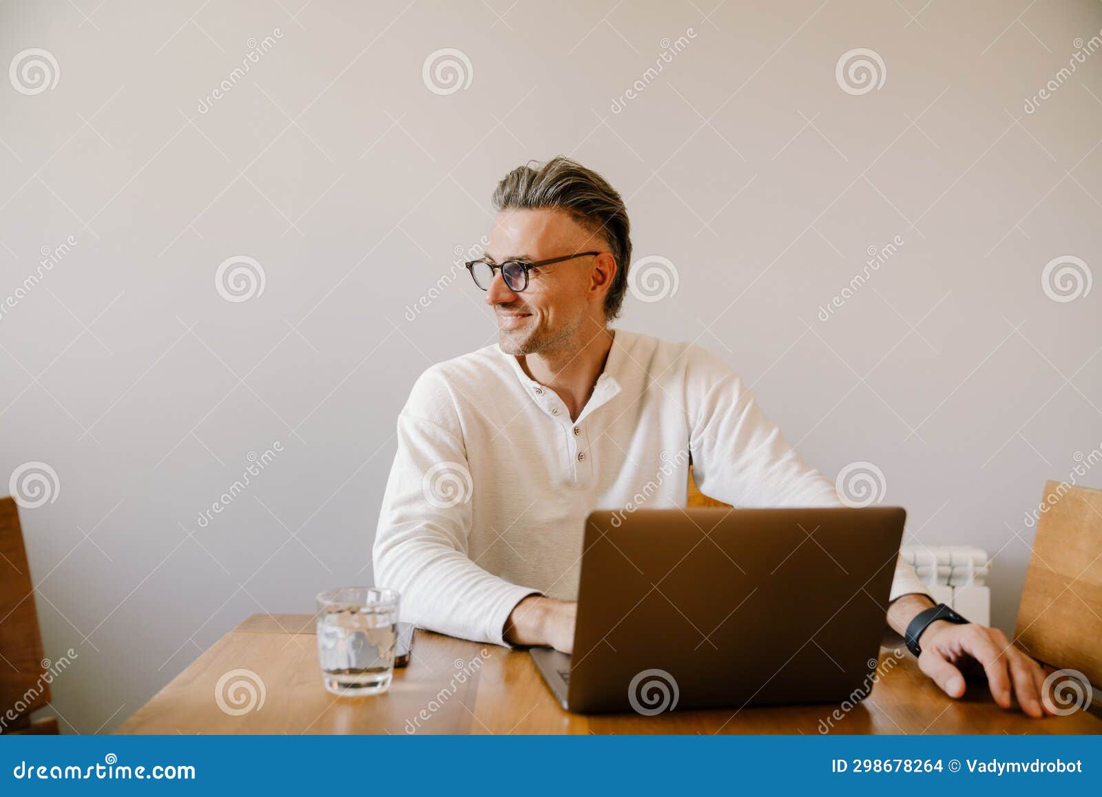 White Mid Man Smiling and Using Laptop while Sitting at Table Stock ...